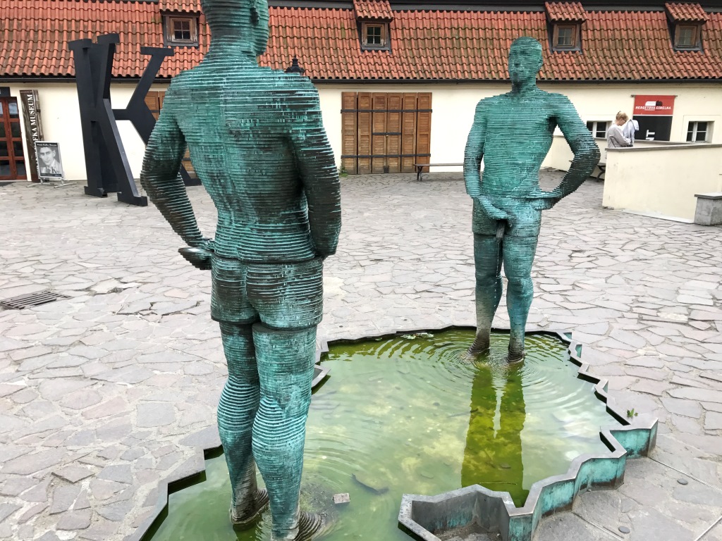 Peeing man sculpture at Kafka Museum | Talk-A-Vino
